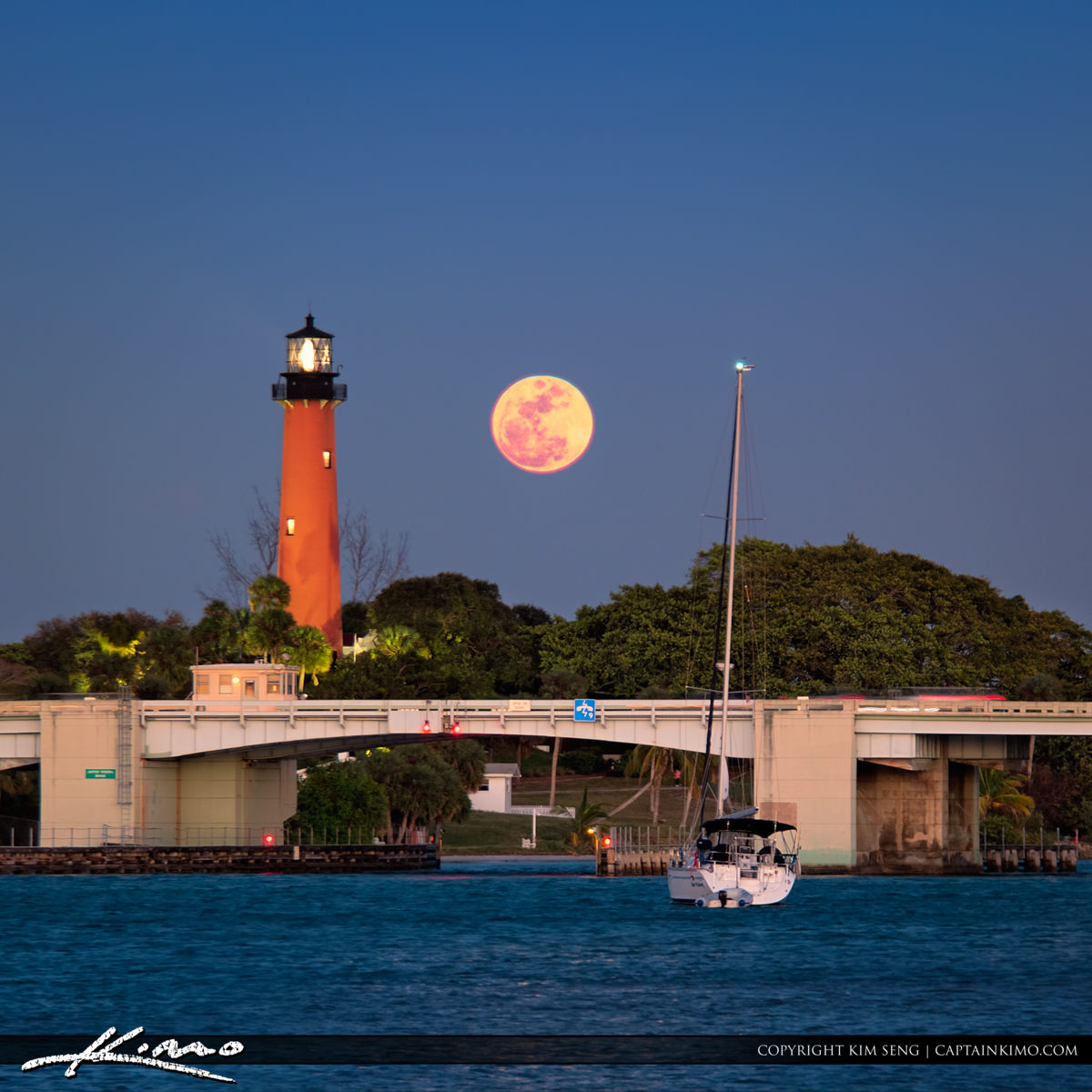 Full Moon Rise Jupiter Inlet Lighthouse and Sailboat | Royal Stock Photo