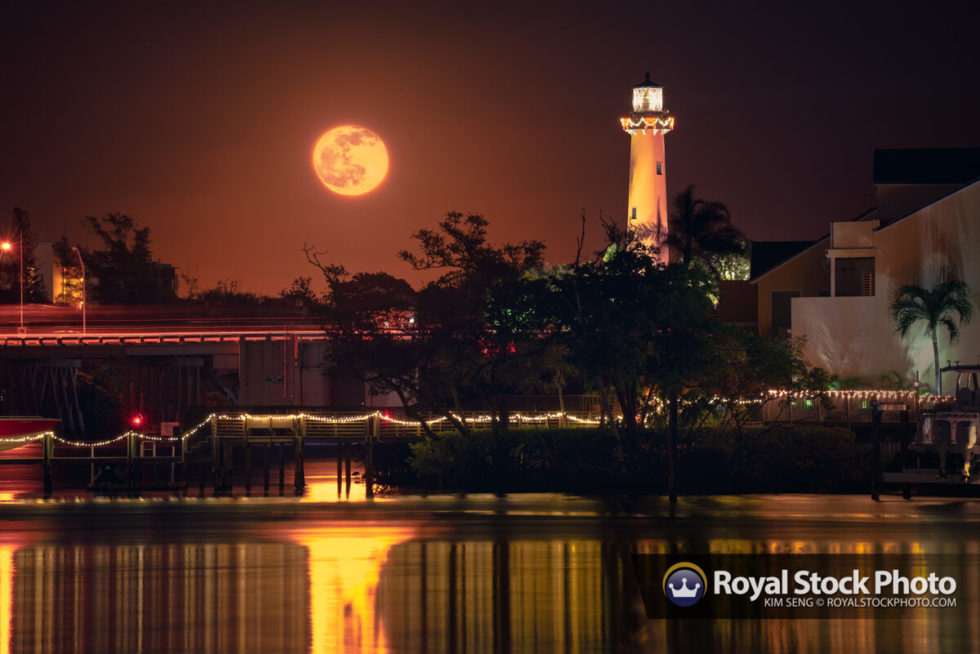 Moon Rising Over the Jupiter Lighthouse Holiday Lights | Royal Stock Photo