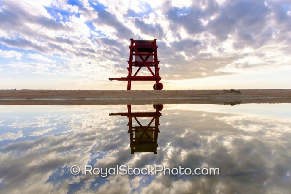 Morning Reflections at Daytona Beach Highlight Lifeguard Stand Amidst Stunning Sunrise on North ...
